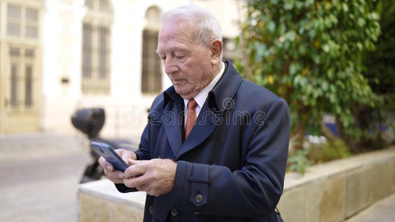 Senior Using Smartphone at Street Stock Photo - Image of conversation ...