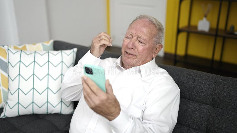 Senior Using Smartphone with Worried Expression at Home Stock Photo ...