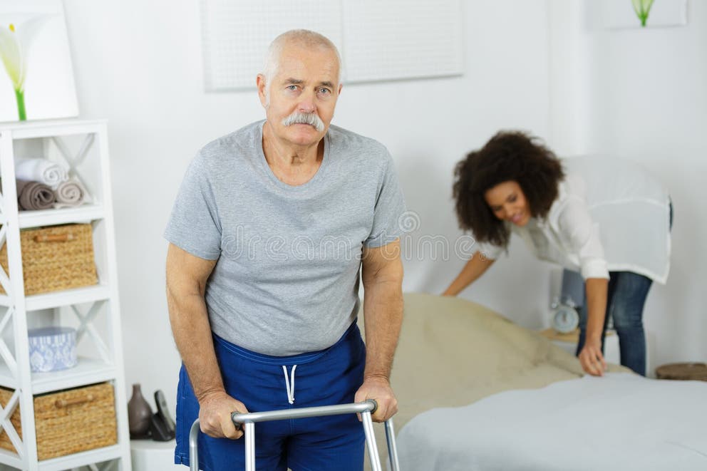 Senior Using Zimmer while Carer in Making Bed Stock Image - Image of ...