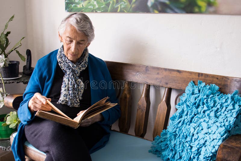 Senior Woman Alone at Home Reading an Old Book Stock Photo - Image of ...