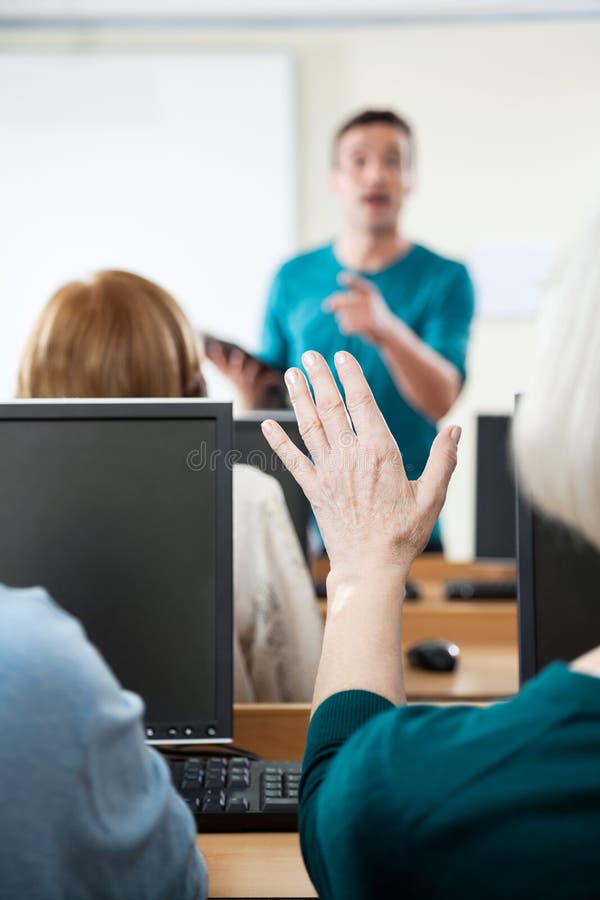 Senior Woman Asking Question in Computer Class Stock Photo - Image of ...