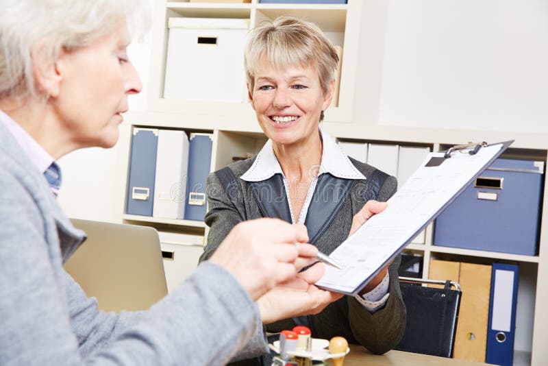 Senior Woman in Bank Signing Stock Image - Image of women, sign: 38207307