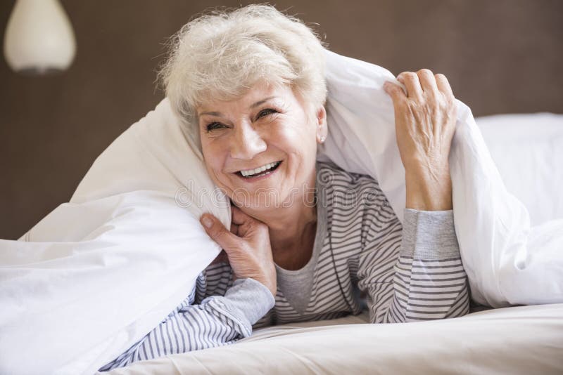 Senior woman in bed stock photo. Image of laughing, interior - 56603046