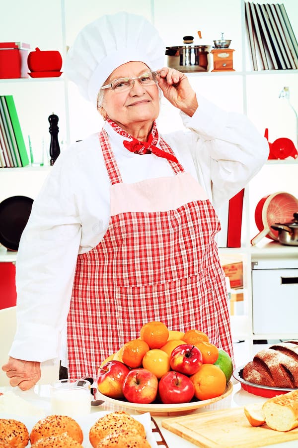 Happy Senior Woman Baking in a Bright Modern Kitchen Stock Image ...