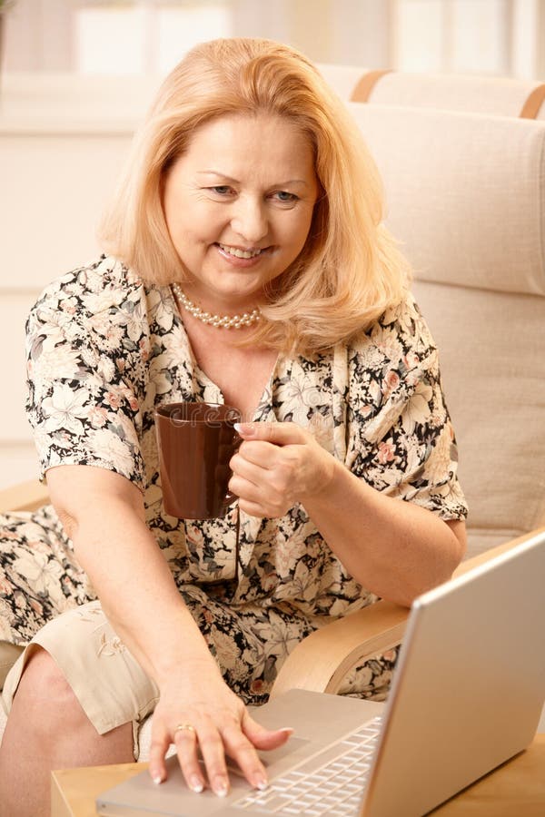 Senior woman with computer stock image. Image of bright - 16501749