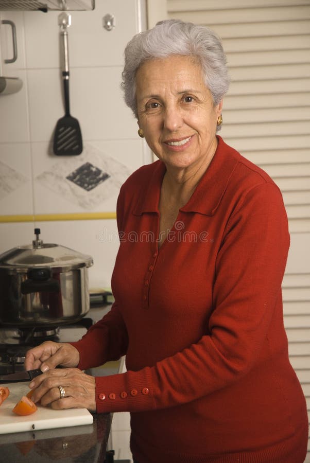 Senior woman cooking stock image. Image of active, woman - 4169387