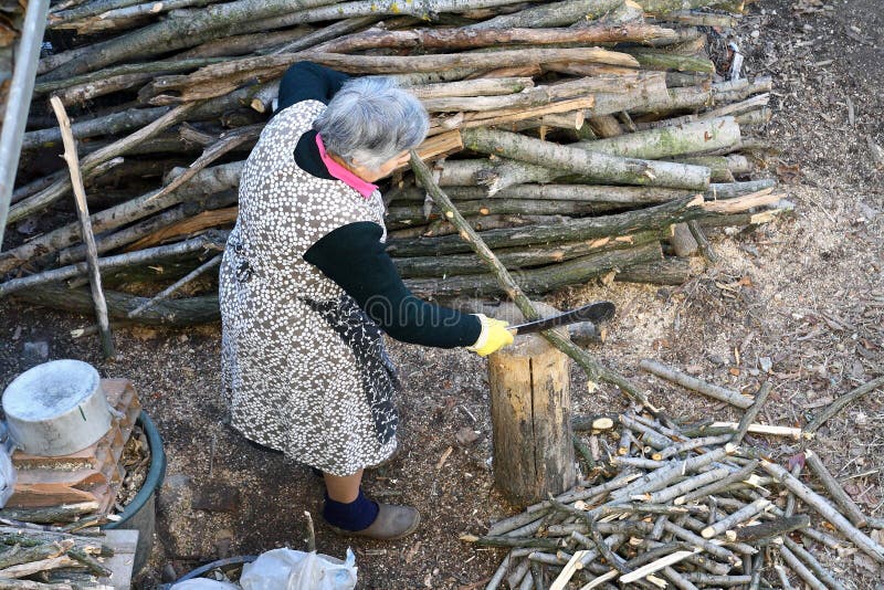 Senior woman cutting wood stock photo. Image of firewood - 23242386