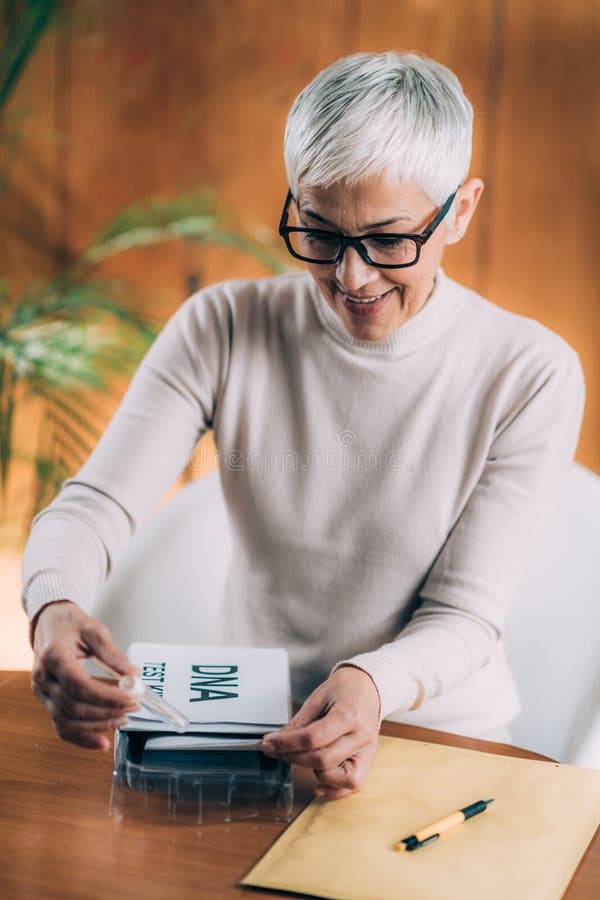 Senior Woman Doing a Mailed DNA Test at Home Stock Image - Image of ...