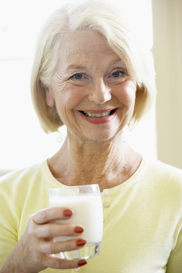 Senior Woman Drinking Milk stock image. Image of indoors - 7875351