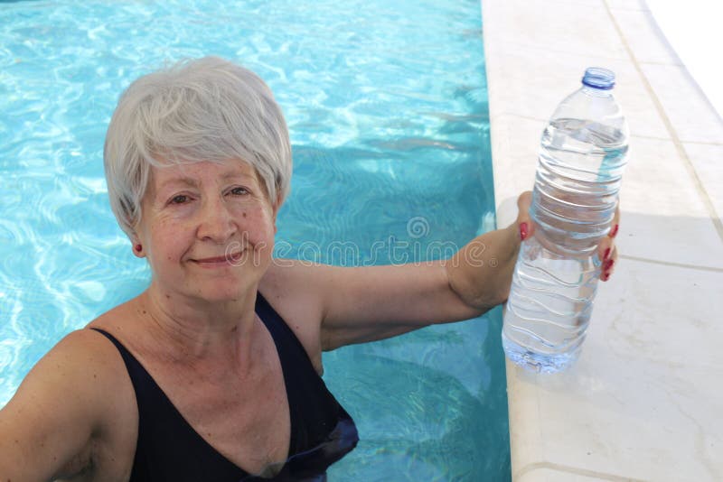 Senior Woman Drinking Water after Working Out in a Pool Stock Photo ...