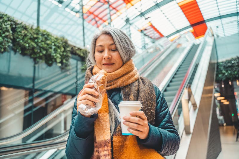 Senior Woman Eats a Sandwitch and Drinks Coffee Stock Image - Image of ...