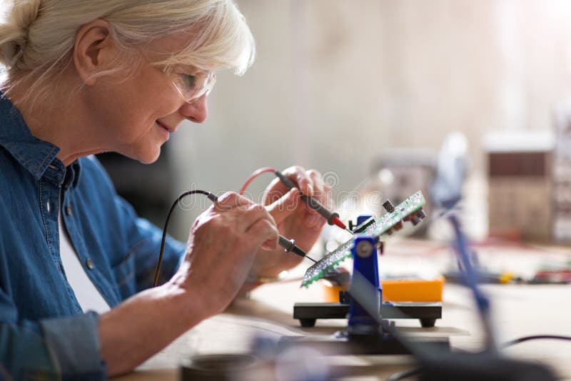 Senior Woman in Electronics Workshop Stock Image - Image of garage ...