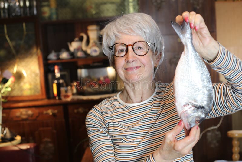 Senior Woman Holding a Delicious Looking Fish Stock Image - Image of ...