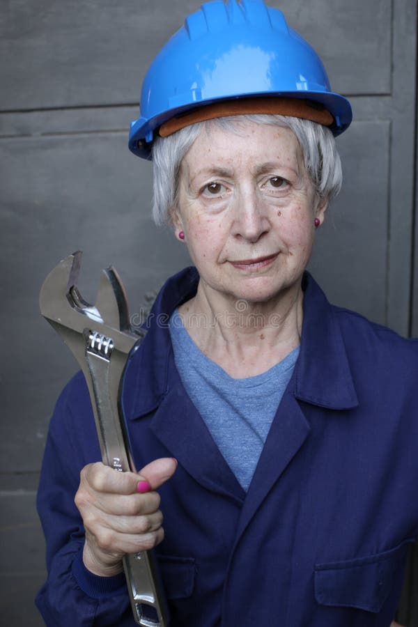 Senior Woman Holding a Heavy Tool Stock Photo - Image of metallic ...