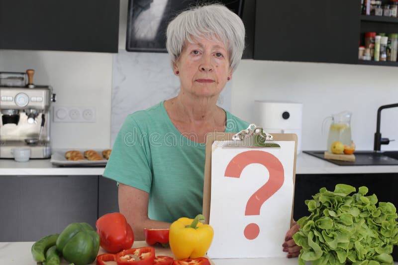 Senior Woman Holding Question Mark in the Kitchen Stock Image - Image ...