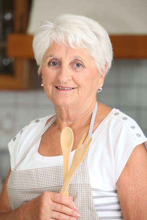 Senior Woman Holding Salad Servers Stock Image - Image of indoors, home ...