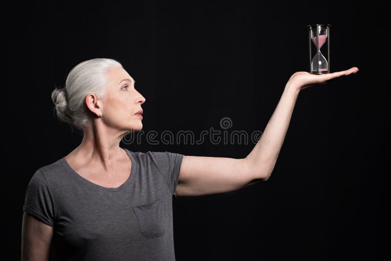Senior Woman Holding Sand Clock Stock Image - Image of serious ...