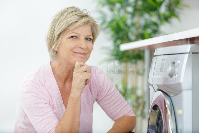 Senior Woman Loading Washing Machine at Home Stock Image - Image of ...