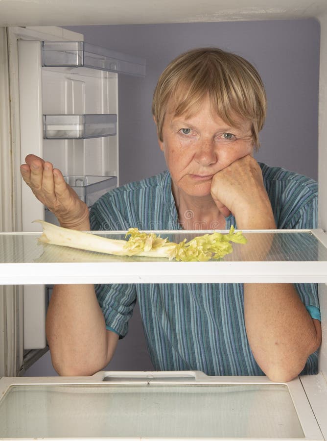 Upset Senior Woman Looking Inside an Empty Fridge Stock Photo - Image ...