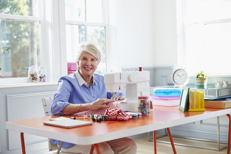 Senior Woman Making Clothes Using Sewing Machine at Home Stock Image ...