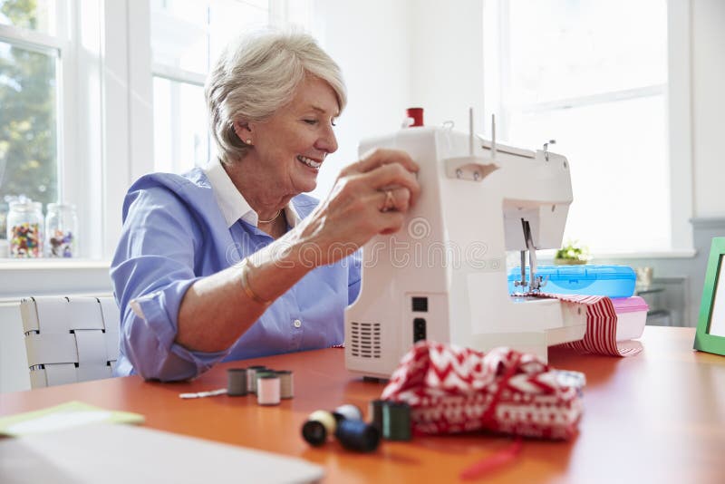 Senior Woman Making Clothes Using Sewing Machine at Home Stock Image ...