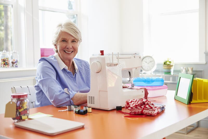 Senior Woman Making Clothes Using Sewing Machine at Home Stock Image ...