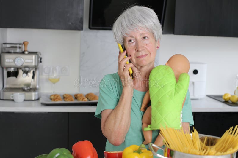 Senior Woman Multitasking in the Kitchen Stock Photo - Image of care ...