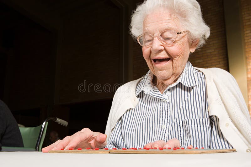 Senior woman playing bingo stock photo. Image of individually - 62809352