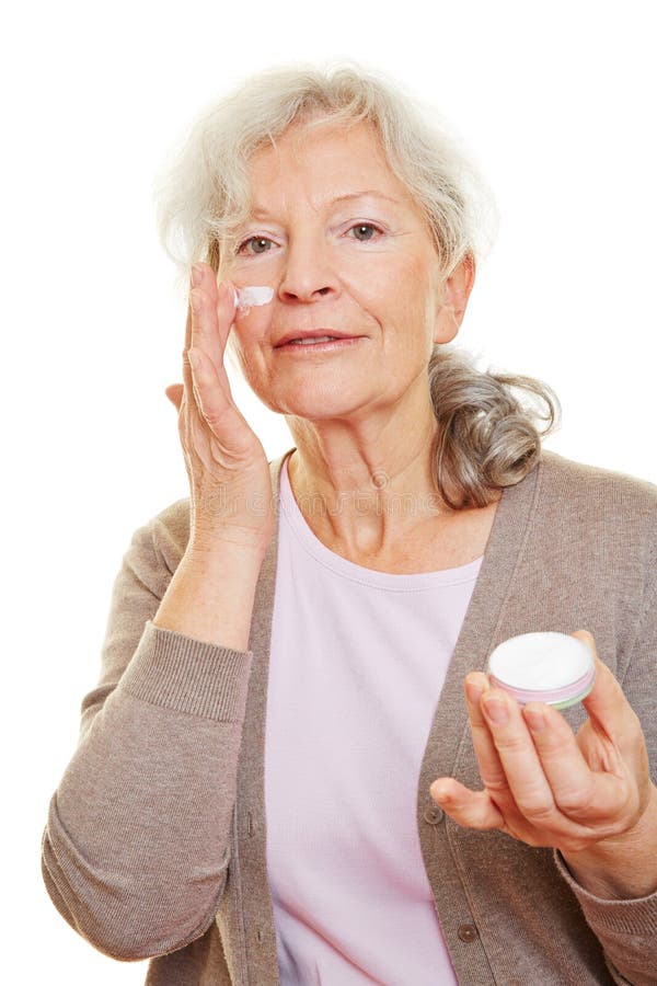 Senior Woman Putting Lotion on Her Stock Photo - Image of facial ...