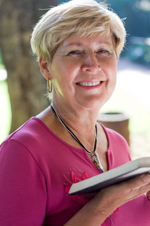 Senior woman reading book stock photo. Image of blond - 5471422