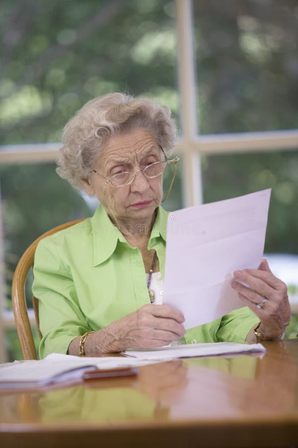 Senior Woman Writing a Check Paying Bill Stock Image - Image of ...
