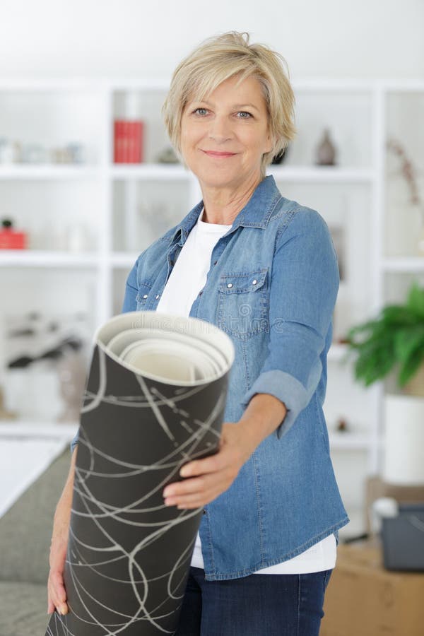 Senior Woman Rolling Out Wallpaper Stock Photo - Image of contractor ...