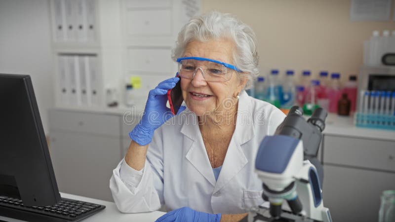 Senior Woman Scientist Smiling while Talking on the Phone in a ...