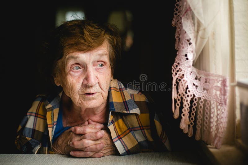 A Senior Woman Seated at a Table Stock Image - Image of indoors ...