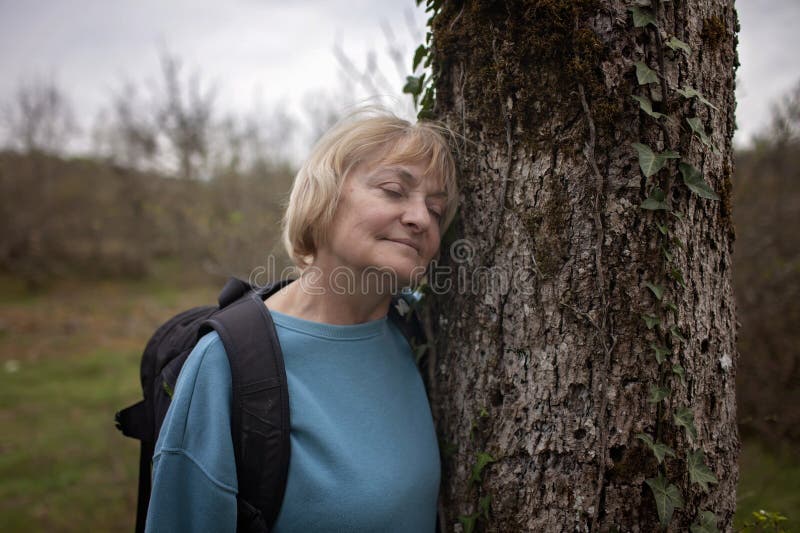 Elderly Lady Resting Against a Tree with Ivy Stock Image - Image of ...