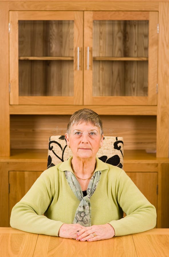 Senior Woman Sitting at Table with Copyspace Above Stock Image - Image ...