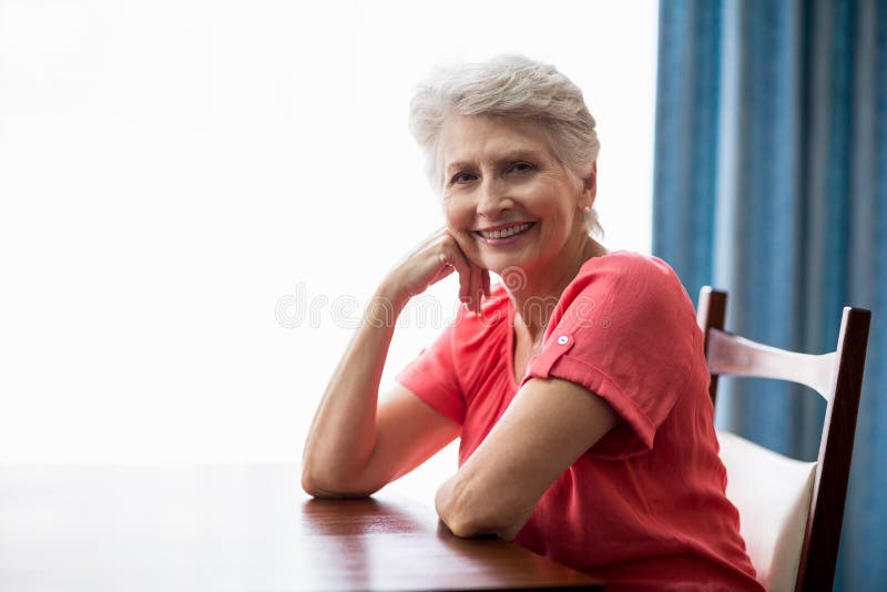 Senior Woman Sitting at a Table Stock Image - Image of healthcare ...