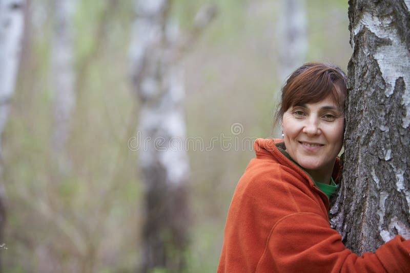 Senior Woman Smiling and Hugging a Birch Tree. Stock Photo - Image of ...