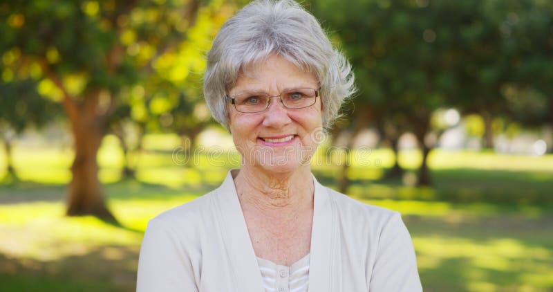 Senior Woman Smiling at the Park Stock Photo - Image of modern, looking ...