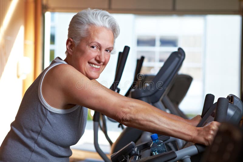 Senior Woman on Spinning Bike Stock Photo - Image of person, machine ...