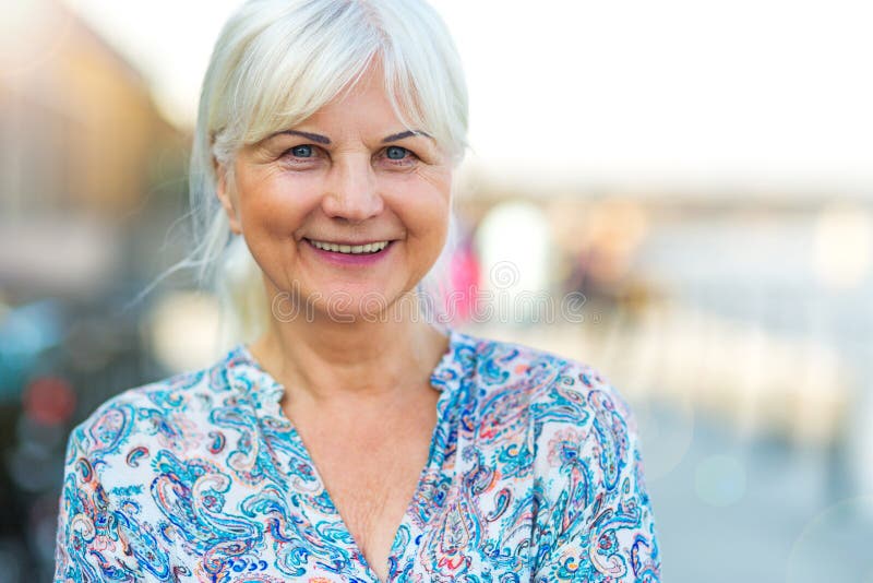 Senior Woman Standing Outdoors Stock Photo - Image of smiling, carefree ...