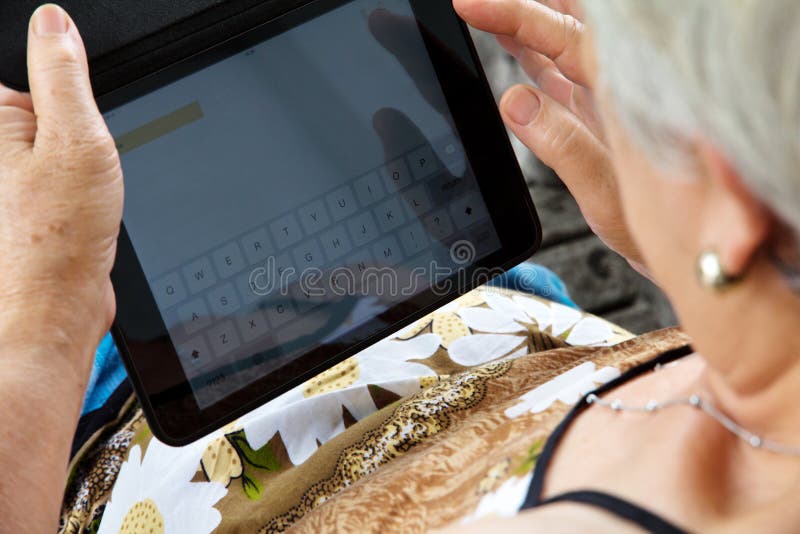 Senior woman with tablet stock photo. Image of finger - 43323516