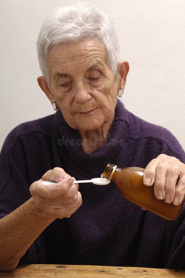 Senior woman taking syrup stock photo. Image of syrup - 63660046
