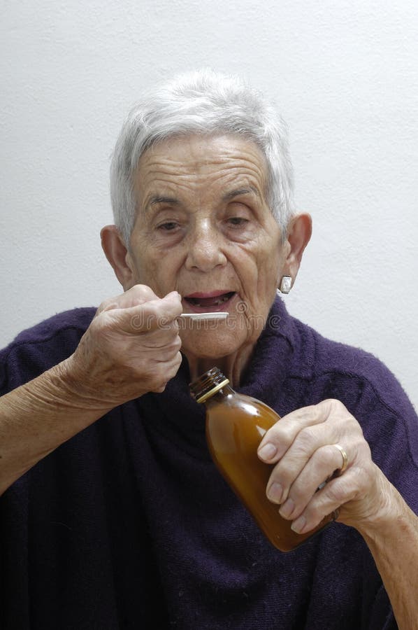 Senior woman taking syrup stock photo. Image of medicine - 63660068