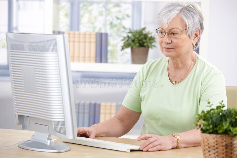 Senior Woman Using Computer at Home Stock Image - Image of horizontal ...
