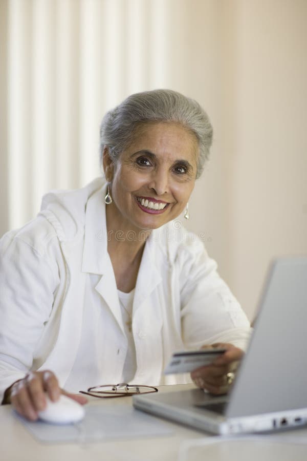 Senior Woman Using Credit Card and Computer Stock Photo - Image of ...