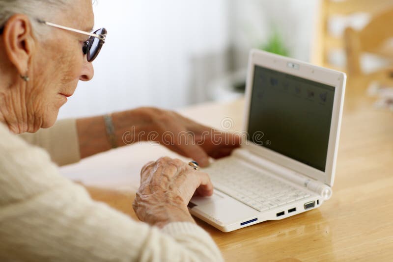 Senior woman using laptop stock image. Image of clever - 7442347