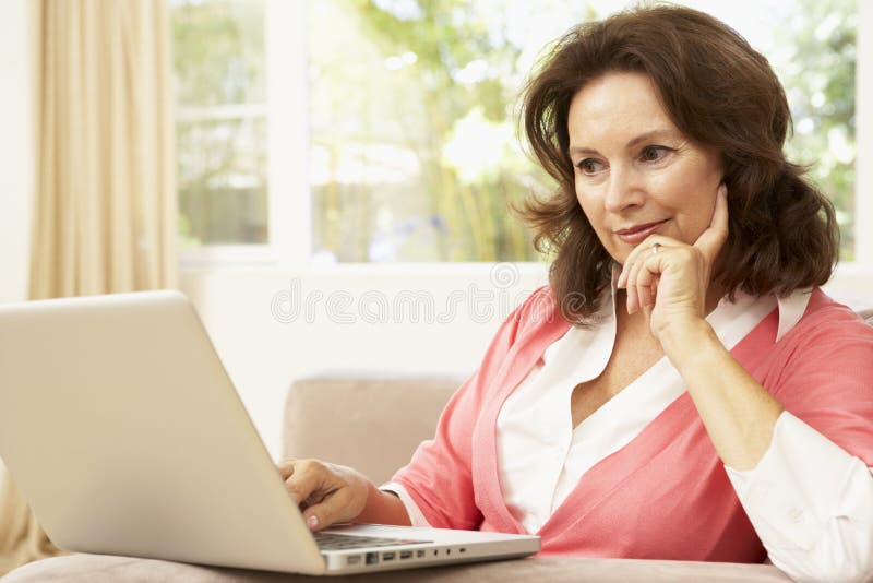 Senior Woman Using Laptop at Home Stock Image - Image of sofa, living ...