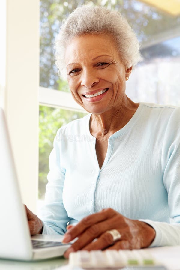 Senior Woman Using Laptop at Home Stock Image - Image of retired ...