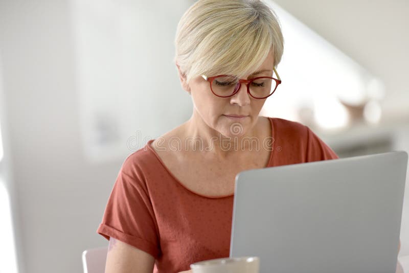 Senior Woman Using Laptop at Home Stock Image - Image of glasses, wifi ...